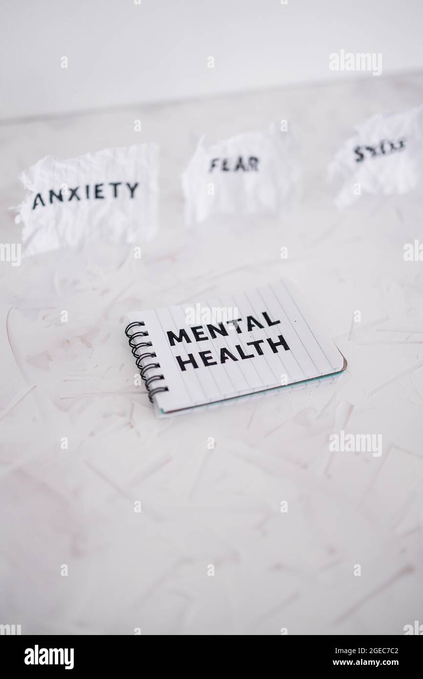 Mental health text on notepad surrounded by Fear Anxiety Stress and ...