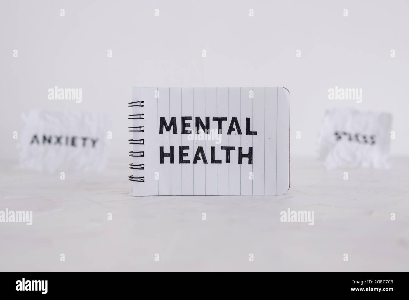 Mental health text on notepad surrounded by Anxiety and Stress words on ...