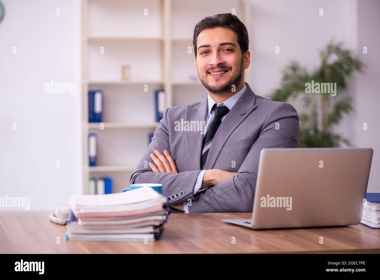 Young male employee working in the office Stock Photo - Alamy