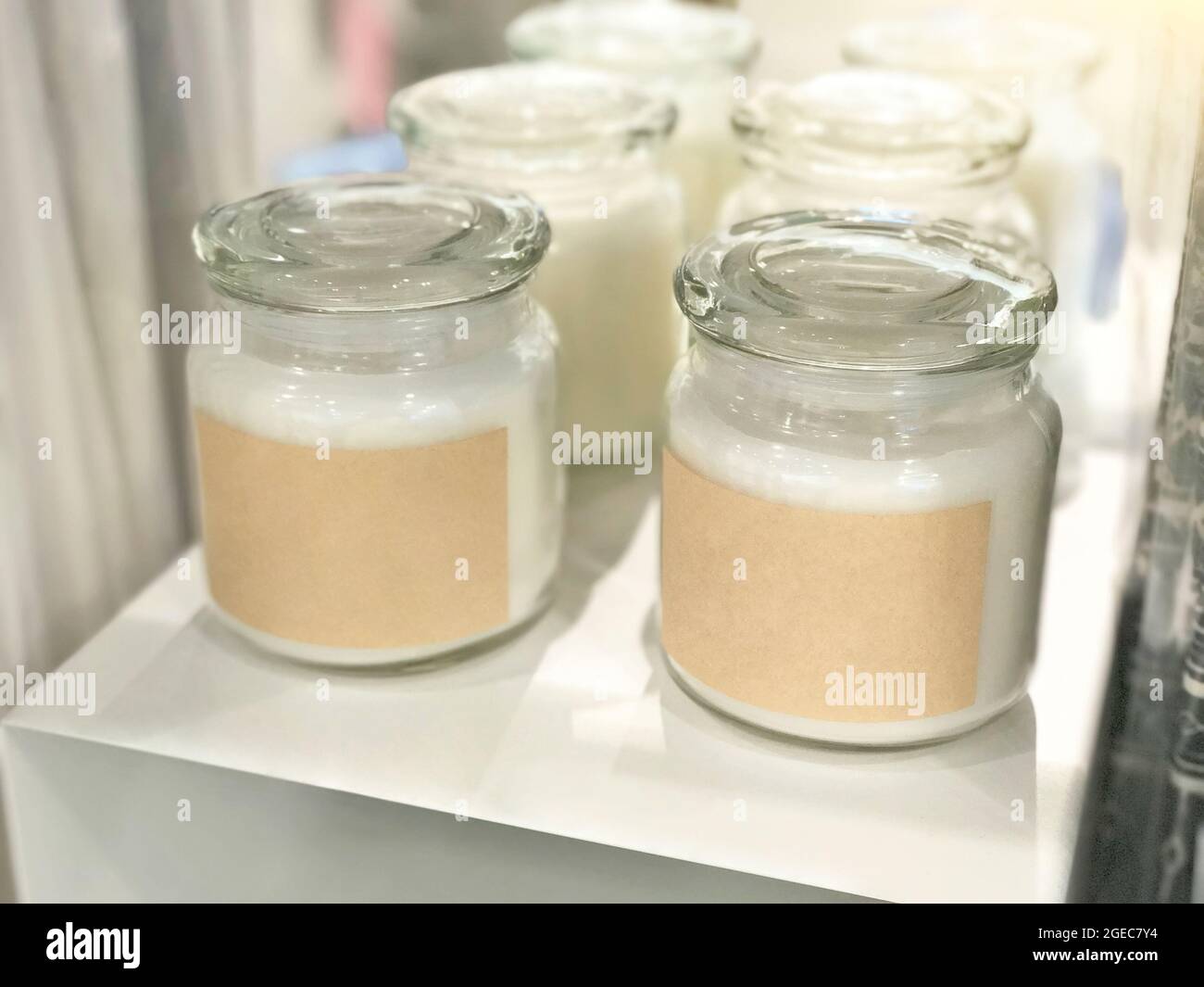 Glass jars with paper labels on the shelf Stock Photo - Alamy