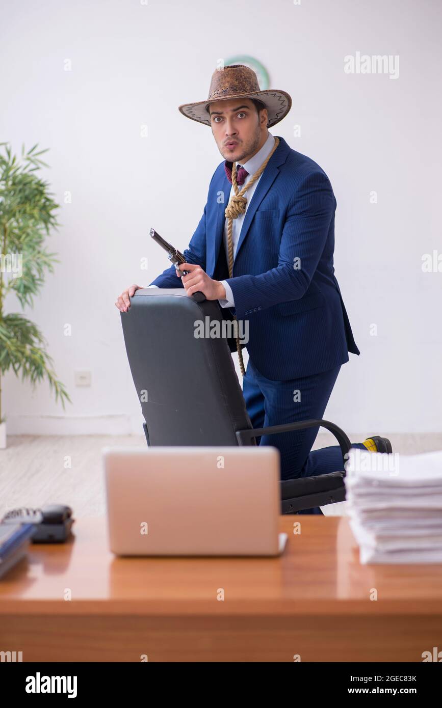Young cowboy employee working at workplace Stock Photo - Alamy