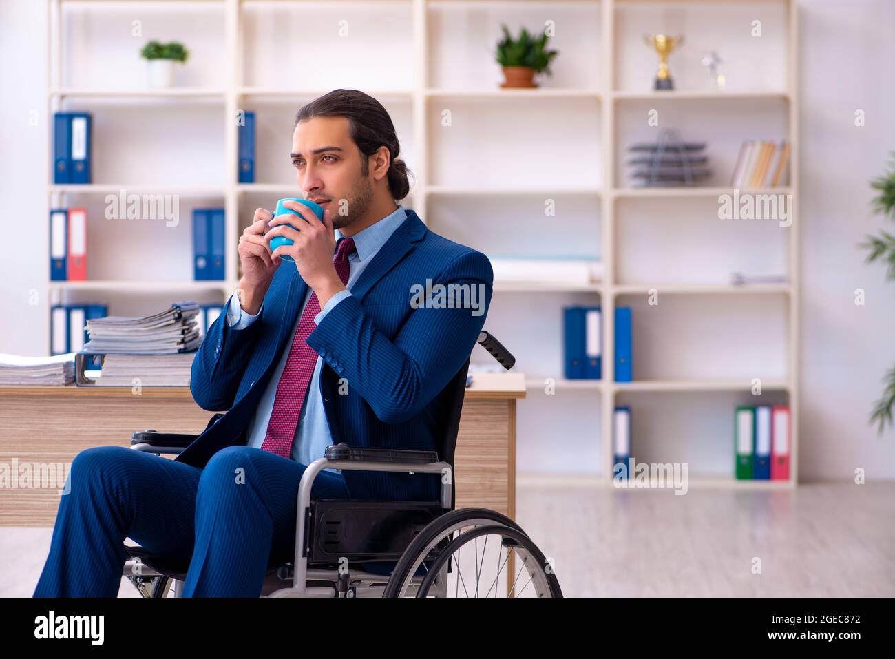 Young male disabled employee working in the office Stock Photo - Alamy