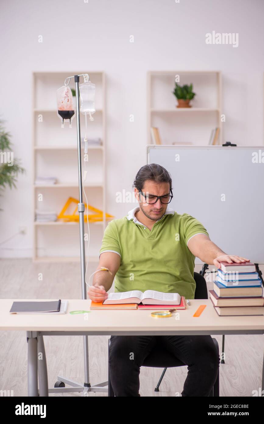 Young sick teacher student in blood transfusion concept Stock Photo - Alamy