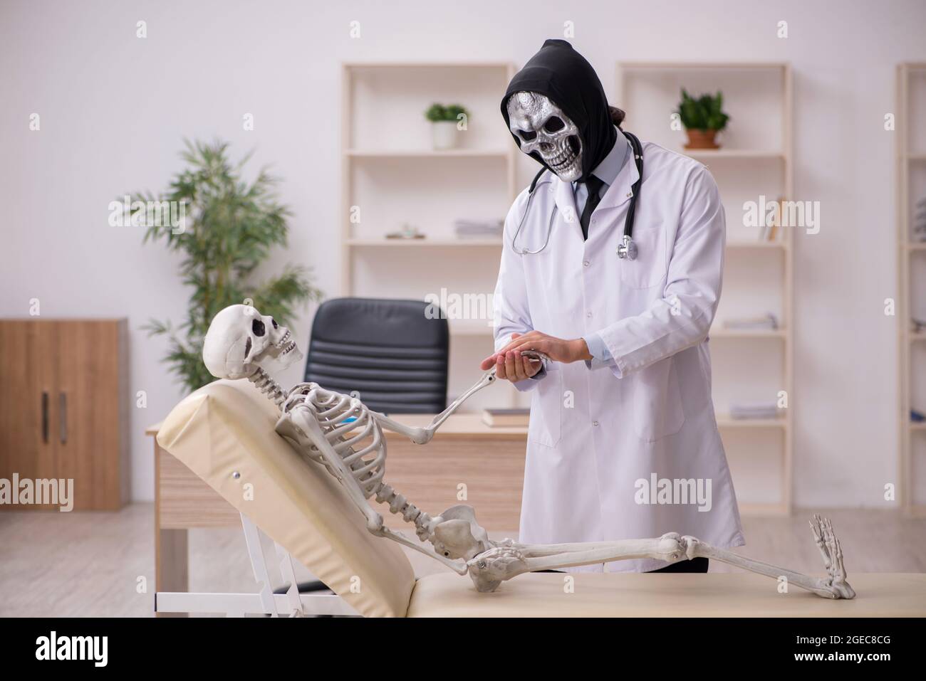 Devil doctor examining skeleton patient in the clinic Stock Photo - Alamy