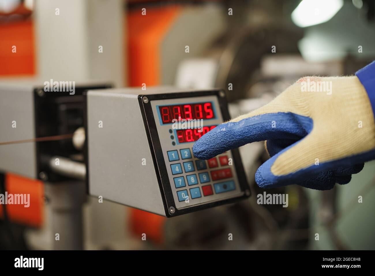 Worker operating a machine in a factory pushing a button Stock Photo ...