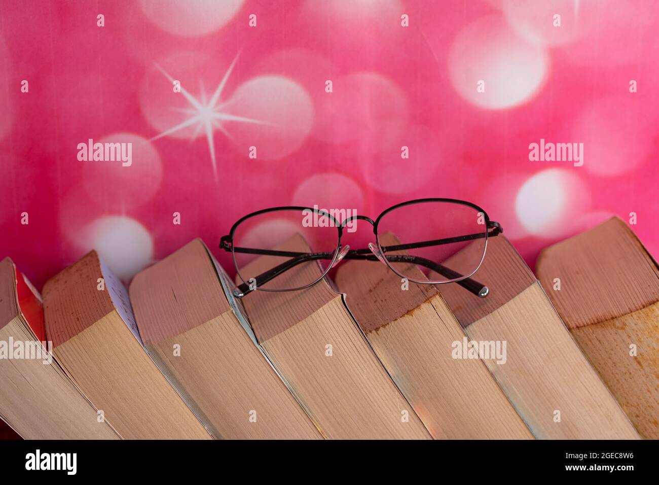 Close-up of a stack of books arranged slanted side by side with reading ...