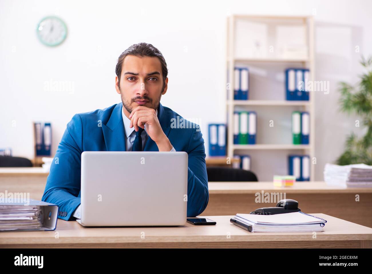 Young employee and too many work in the office Stock Photo - Alamy