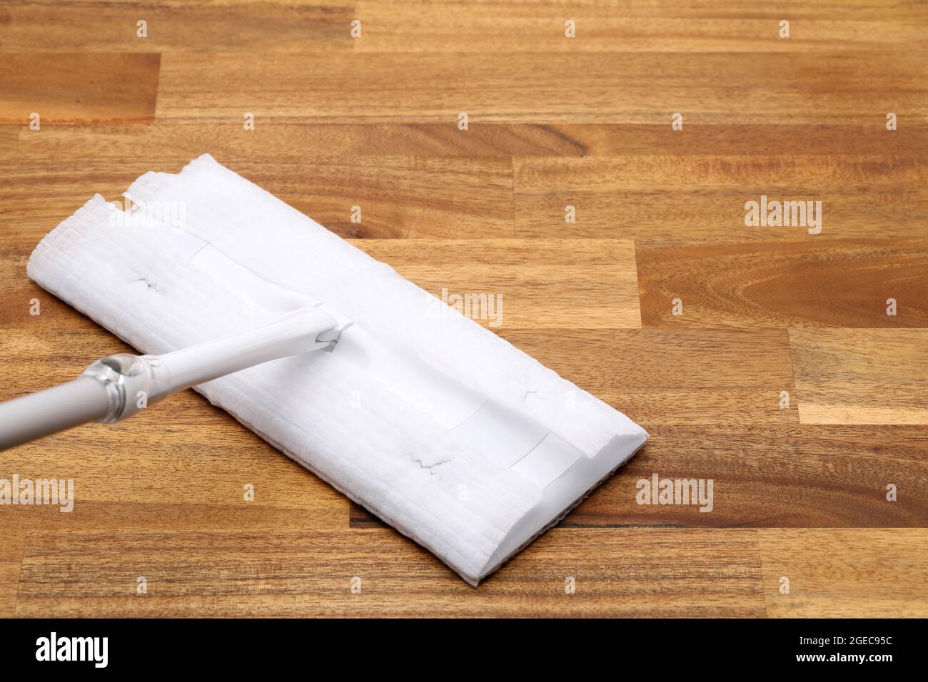 Part of flat wet paper mop and disposable working head on wooed floor ...