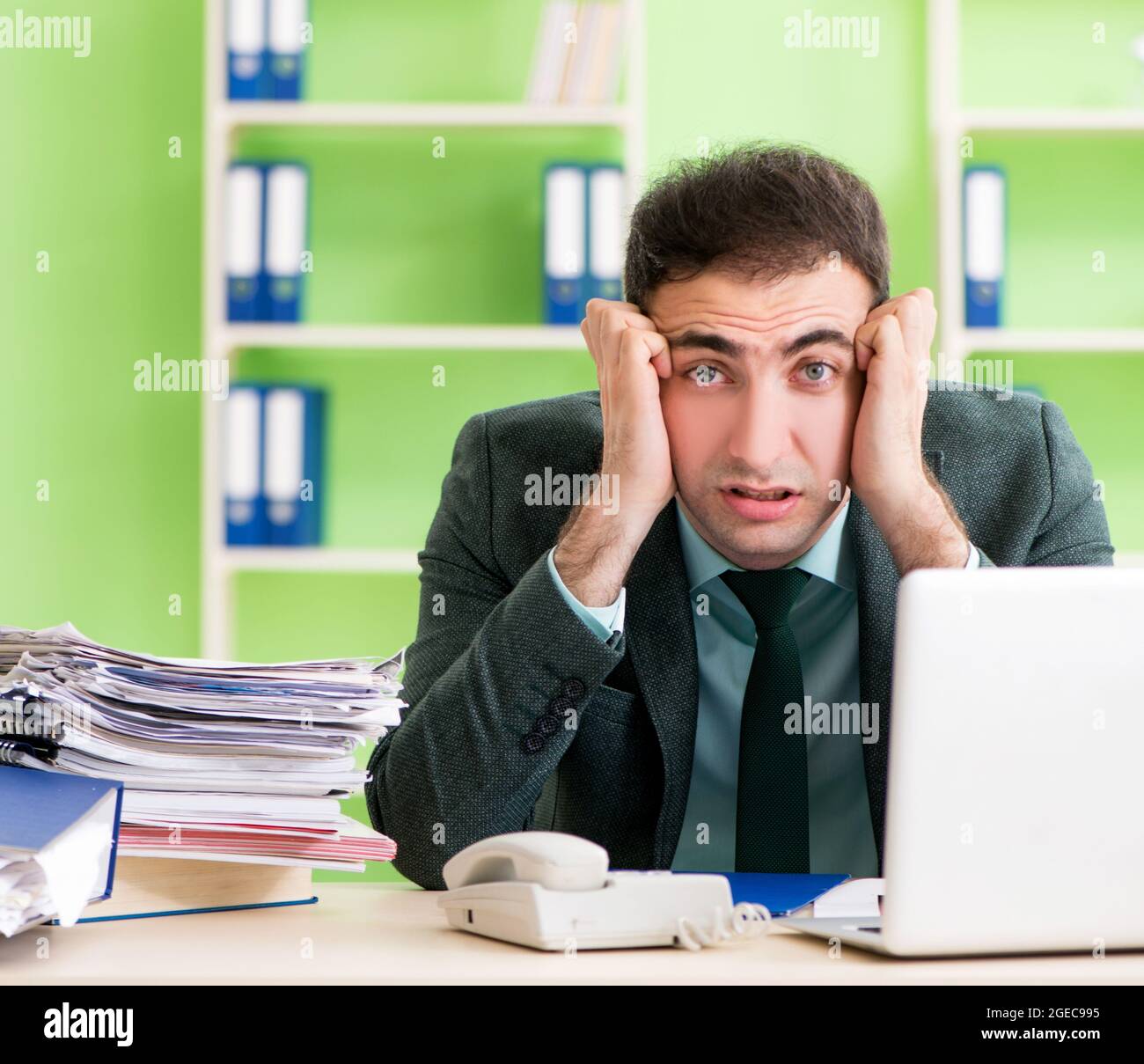 The businessman angry with excessive work sitting in the office Stock ...