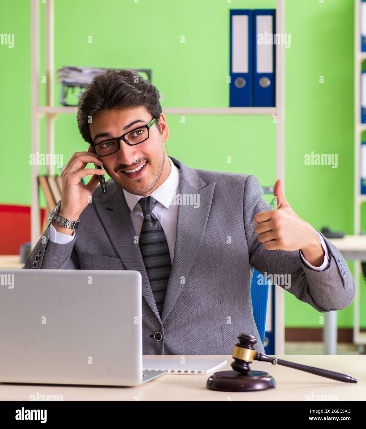The young handsome lawyer working in the office Stock Photo - Alamy