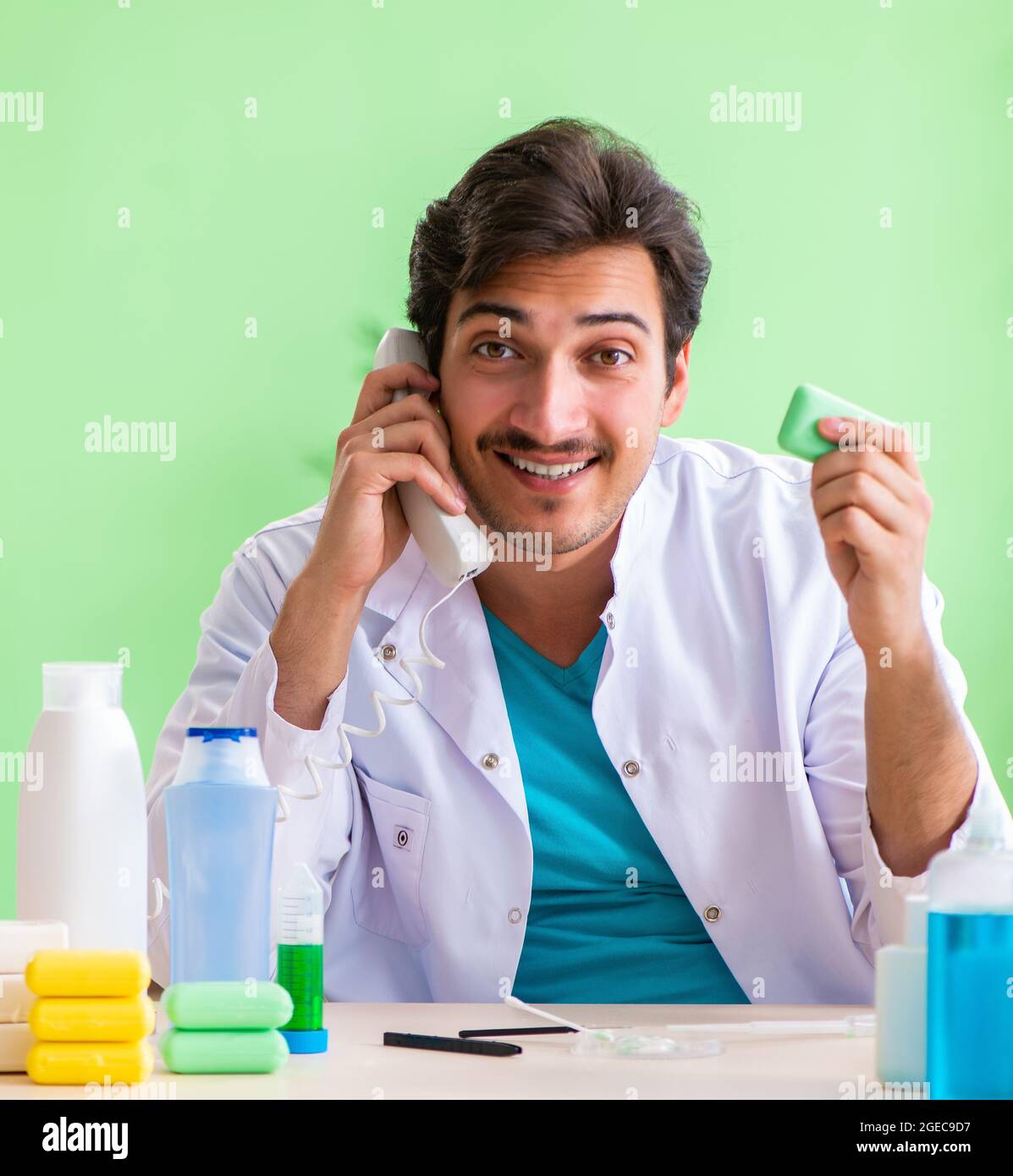 Chemist examining liquid solution speaking hi-res stock photography and ...