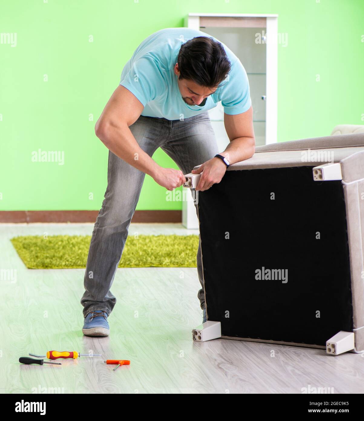 The man repairing furniture at home Stock Photo - Alamy