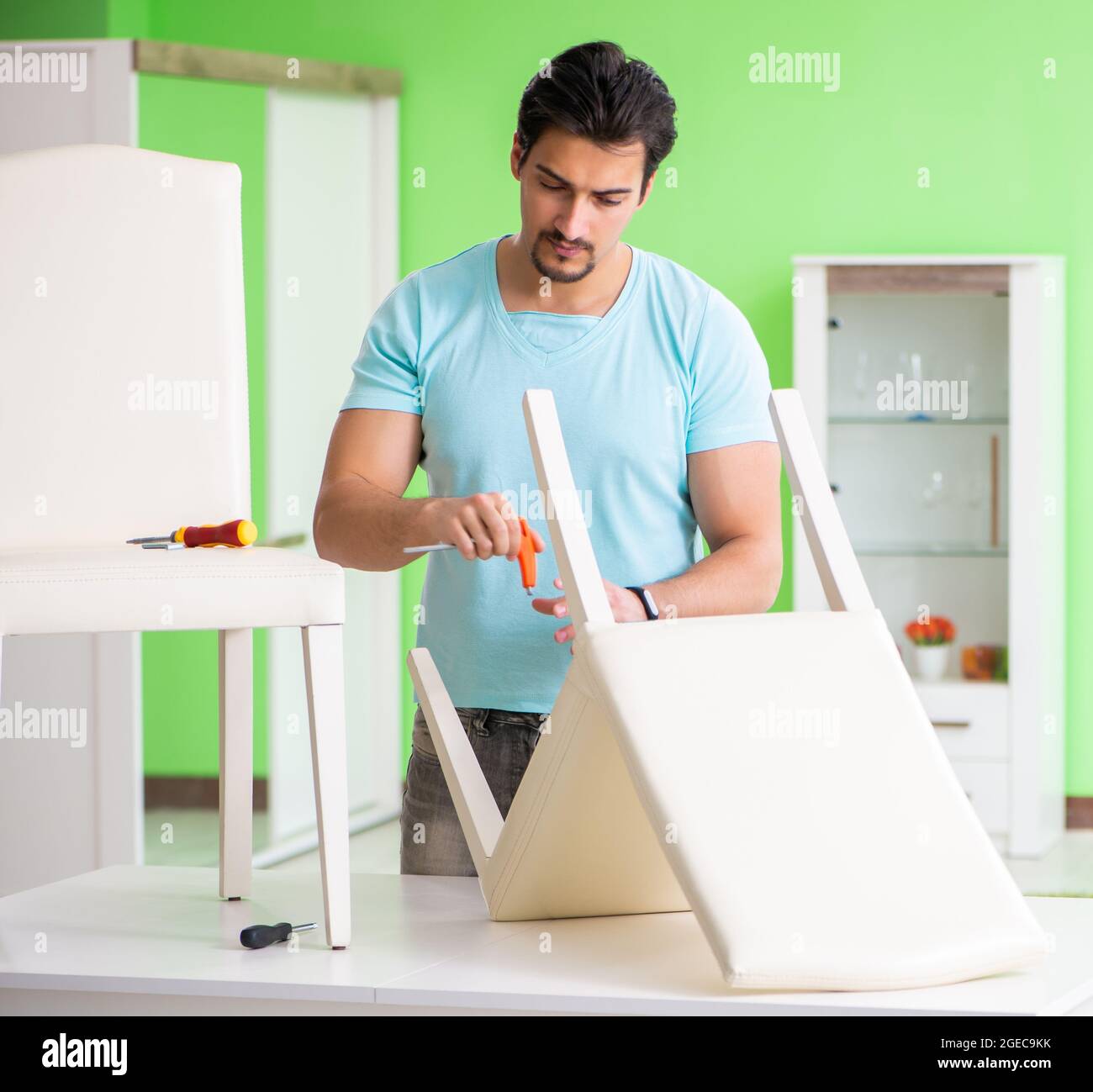 The man repairing furniture at home Stock Photo - Alamy