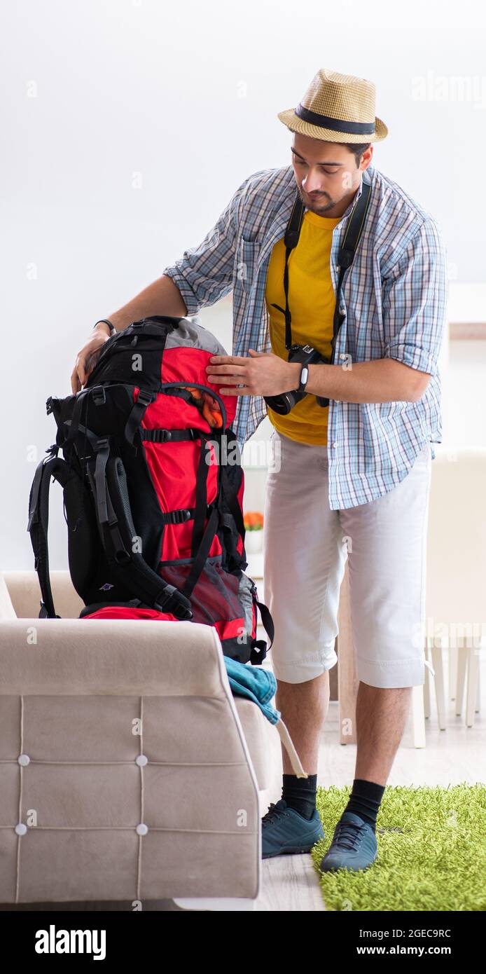 The backpacker packing for his trip Stock Photo - Alamy