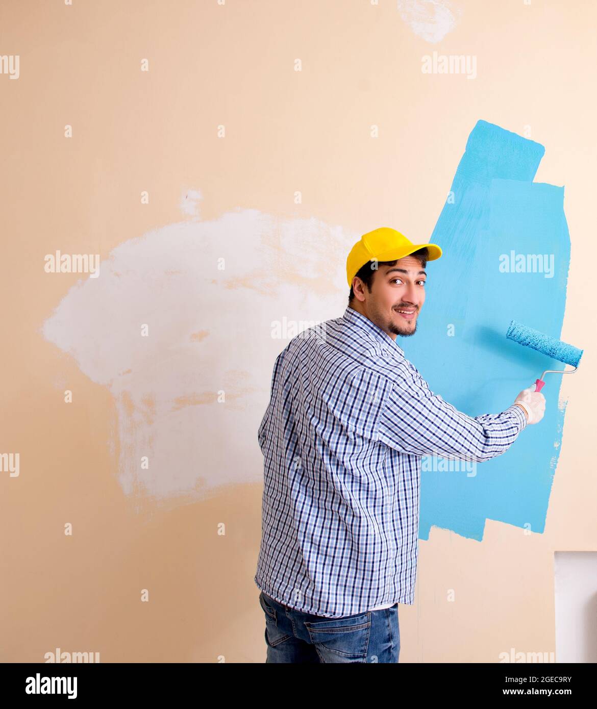 The painter man painting the wall at home Stock Photo - Alamy