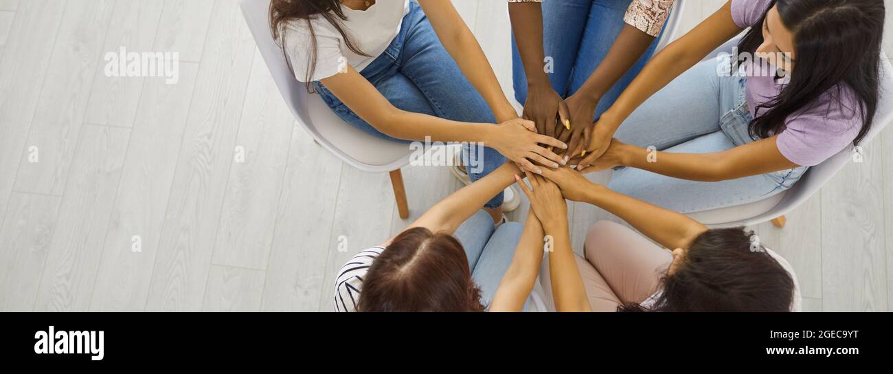 Banner with overhead view of team of young women sitting in circle and ...