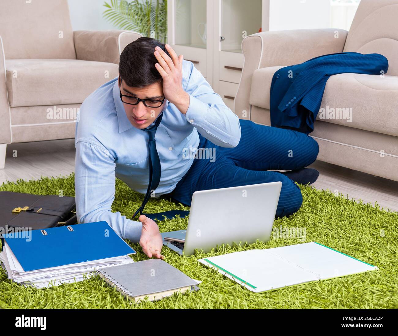 The businessman taking work home and working overtime Stock Photo - Alamy