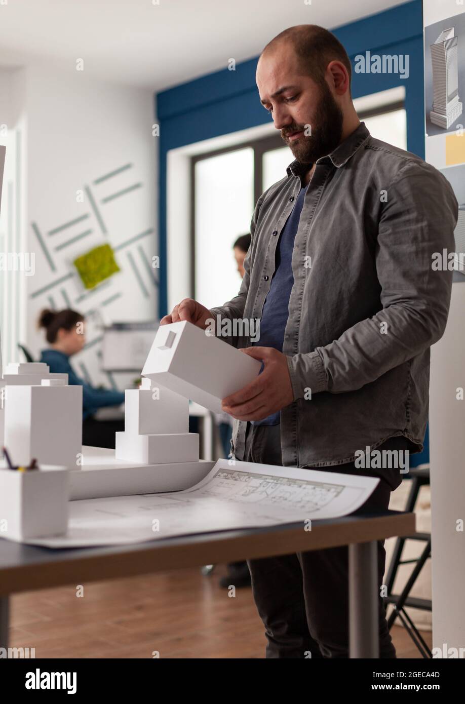 Architecture expert person looking at maquette building model design ...