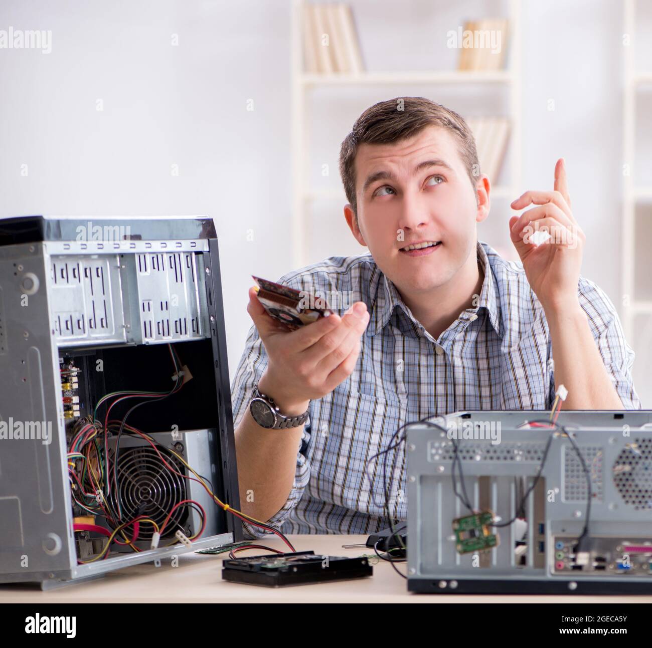 The young technician repairing computer in workshop Stock Photo - Alamy