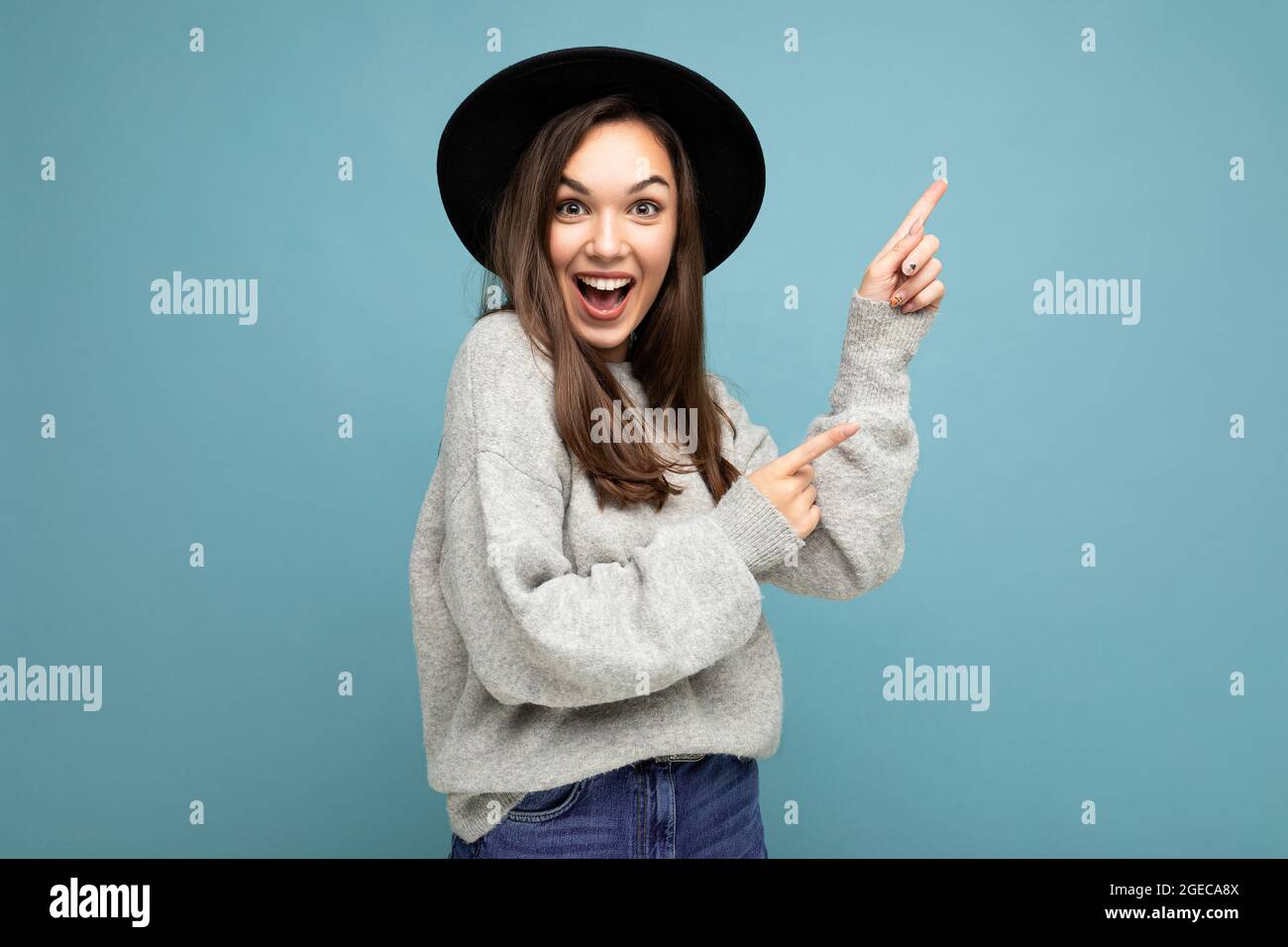 Photo of pretty brunette positive amazed young woman directing fingers ...