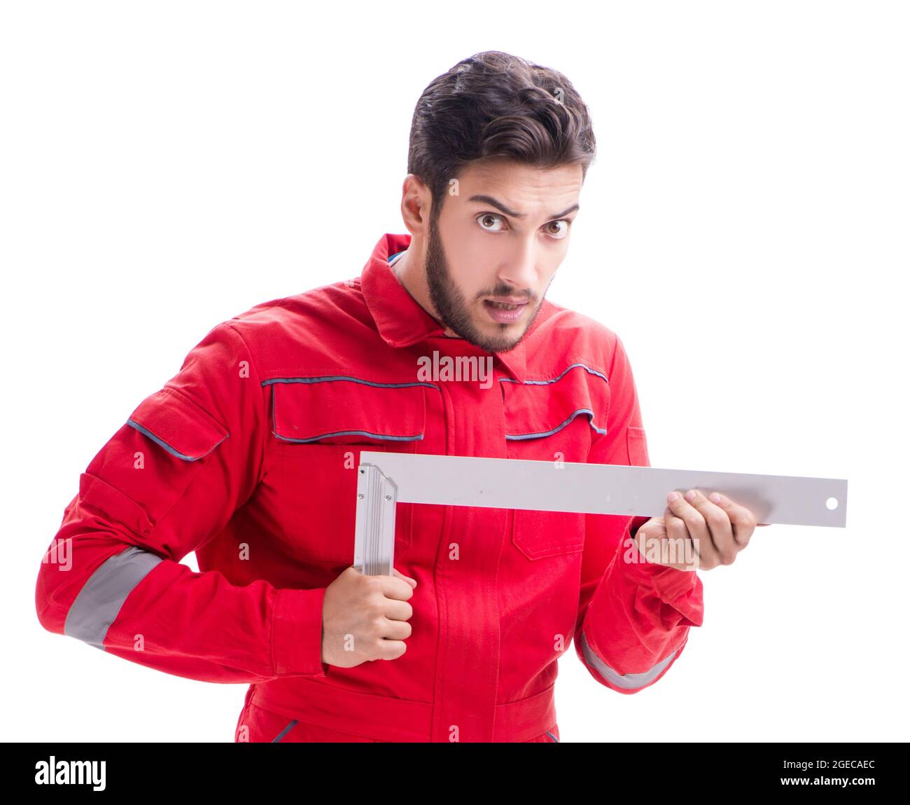 The young repairman with a square ruler isolated on white background ...