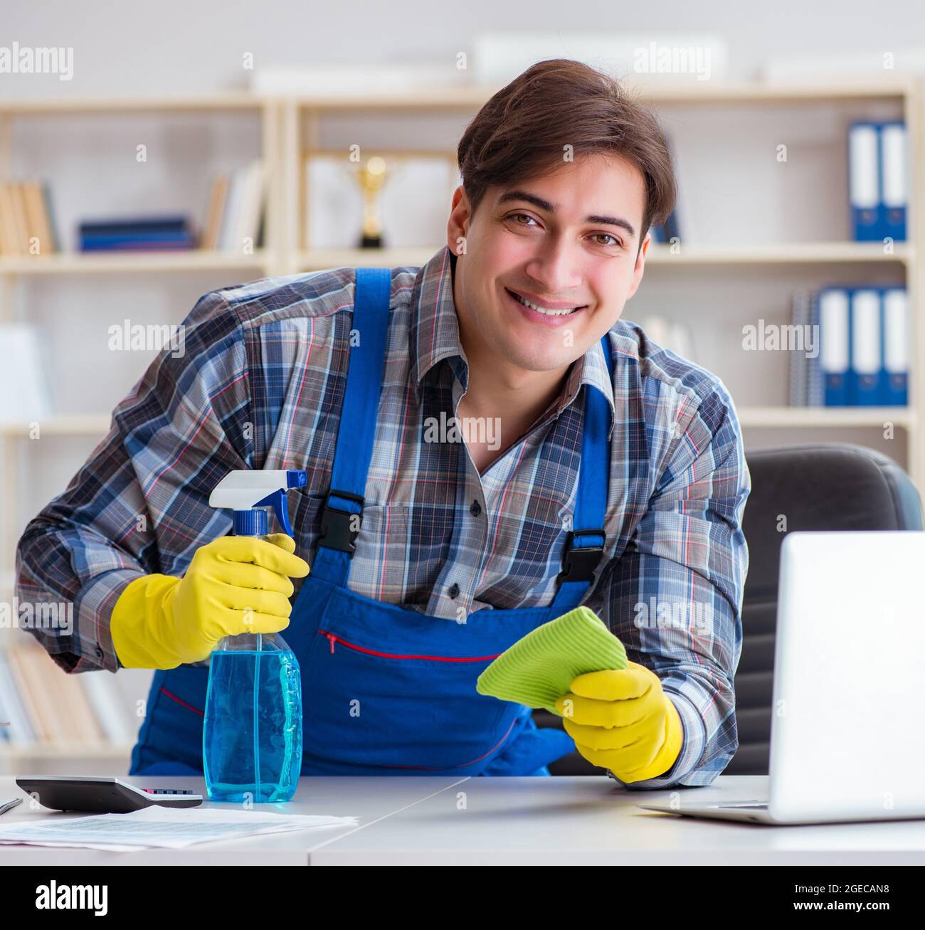The male cleaner working in the office Stock Photo - Alamy