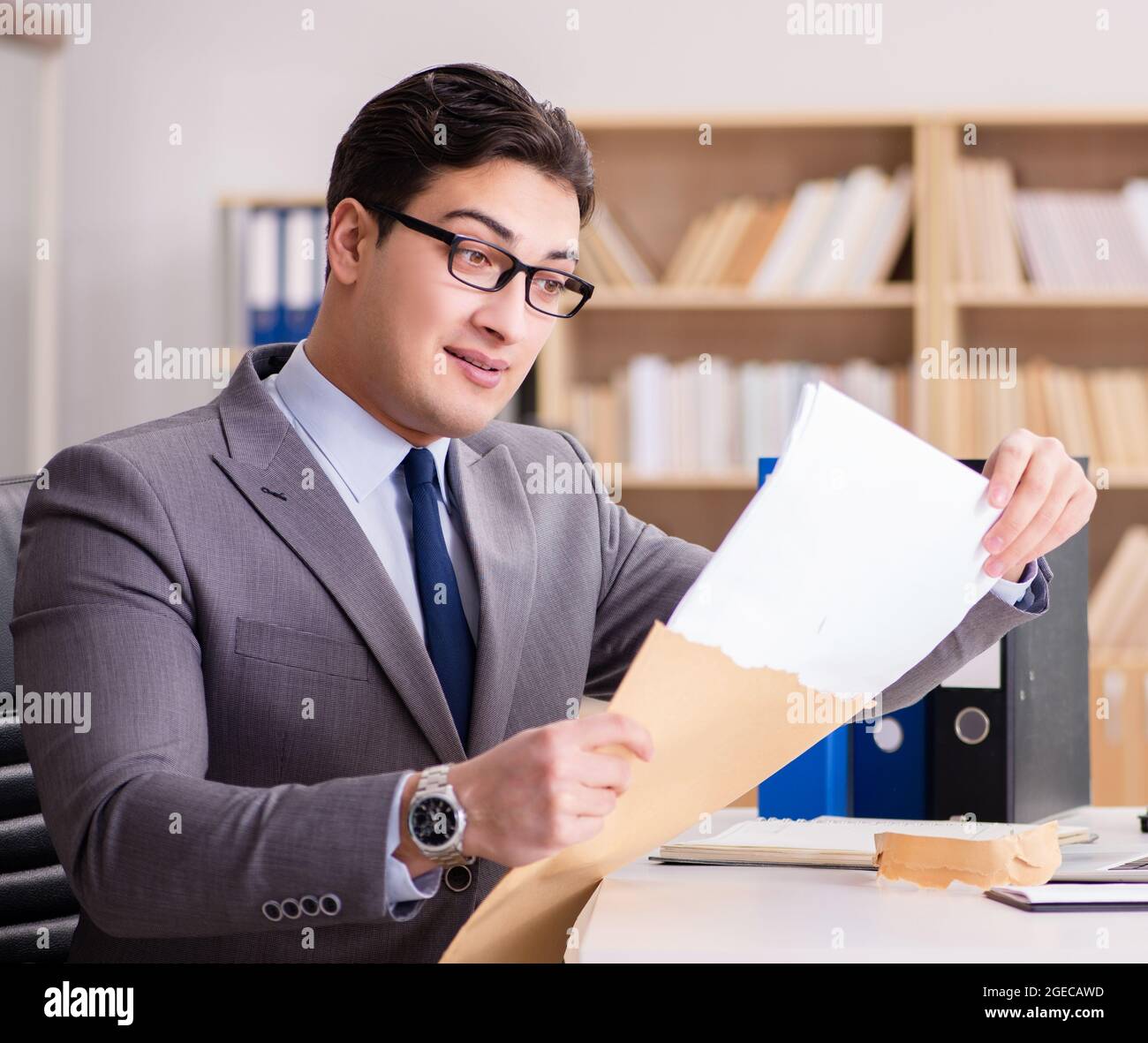 The businessman receiving letter in the office Stock Photo - Alamy