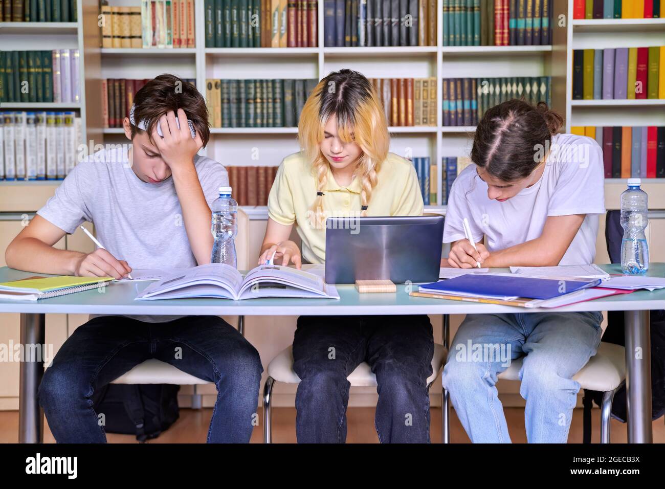 Group of teenage students studying in school library Stock Photo - Alamy