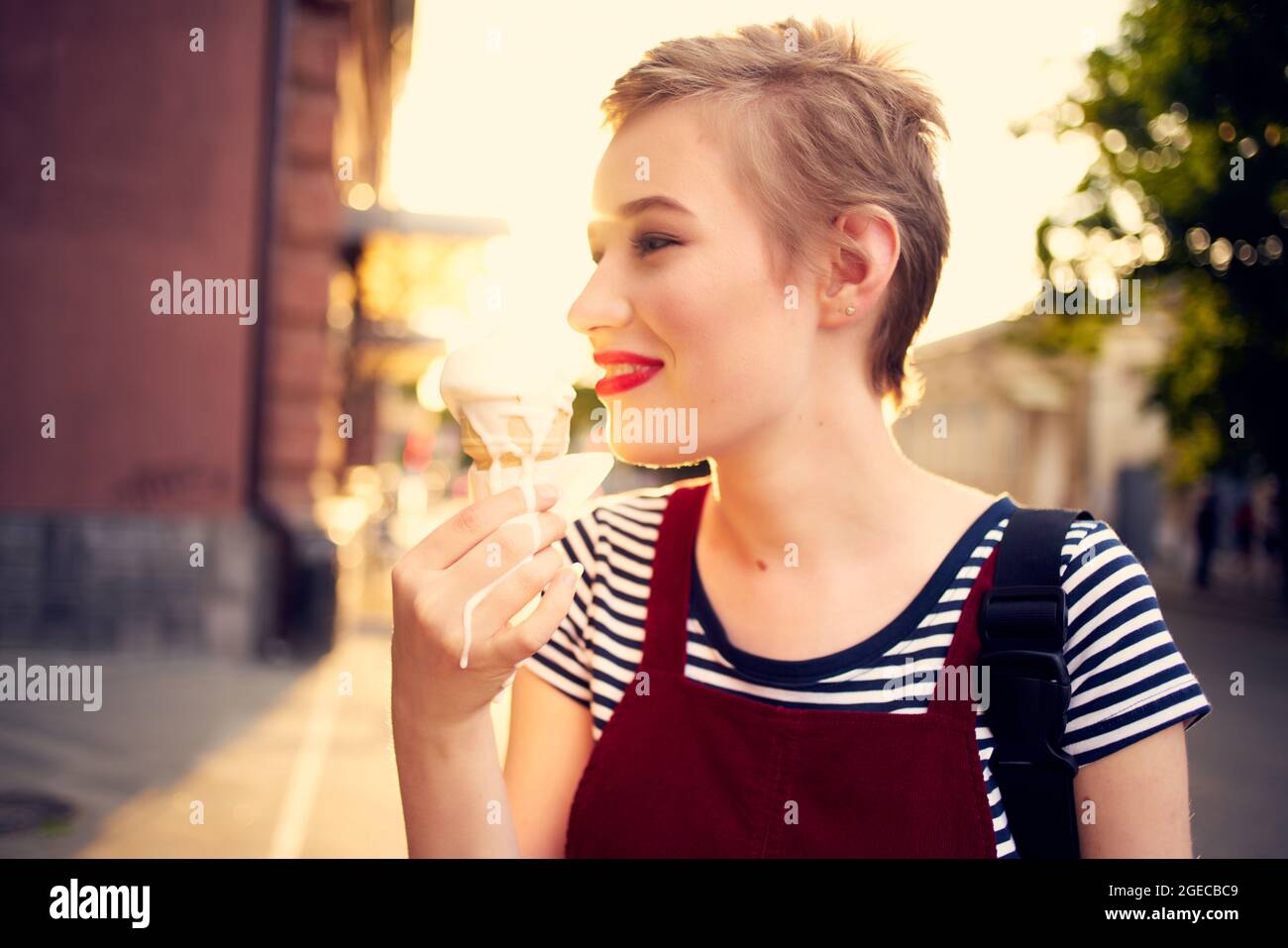 pretty woman outdoors eating ice cream walk Stock Photo - Alamy
