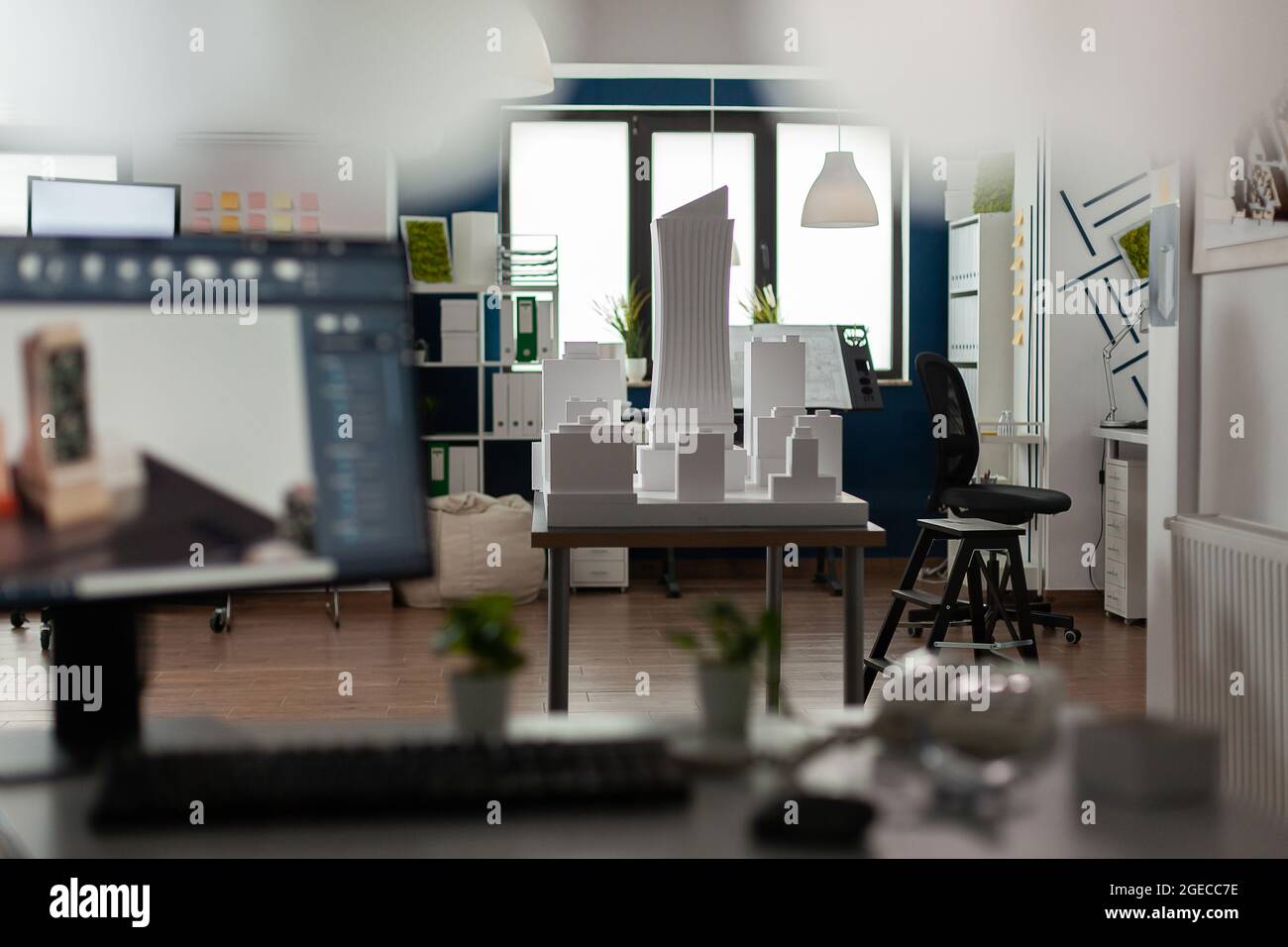 Empty architectural room for design and modern computer with blueprint ...
