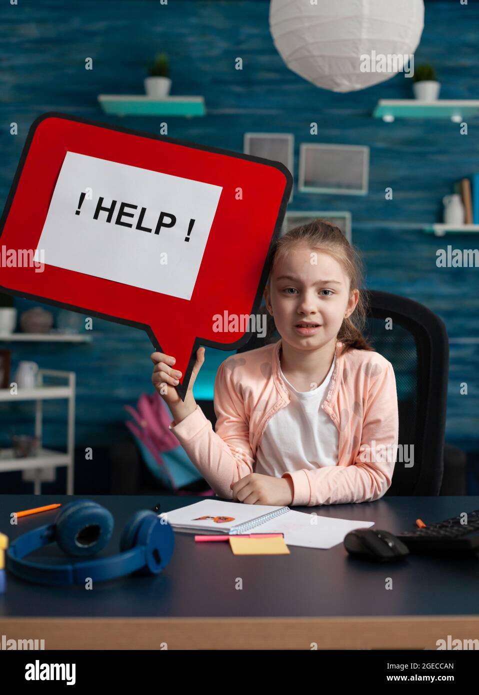 Conceptual image of elementary school kid with sign asking for help ...