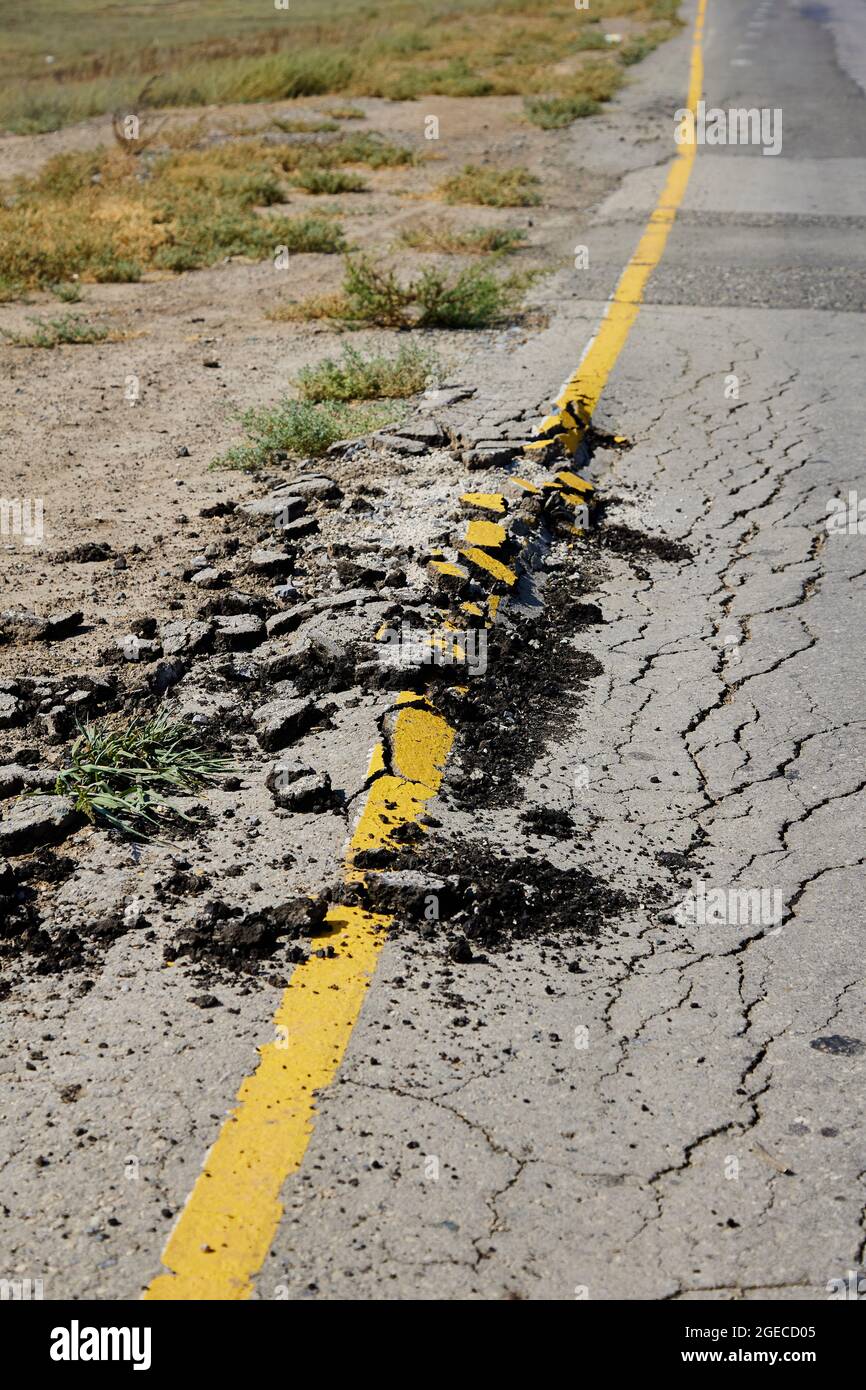 Destroyed roadside of country highway. Poor condition requires repair ...