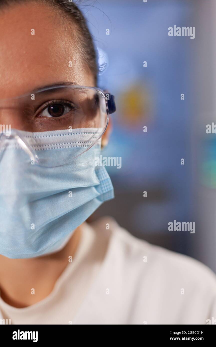 Close up of scientist woman with glasses and face mask in medical ...