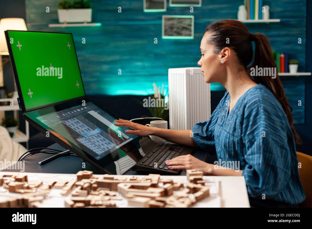 Architecture manager with design plan and green screen on computer ...