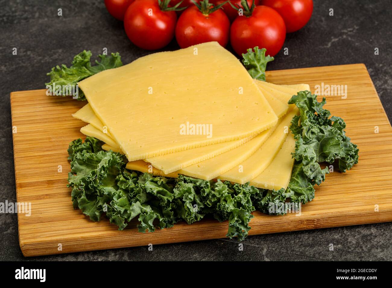 Sliced Gauda cheese snack over board Stock Photo - Alamy