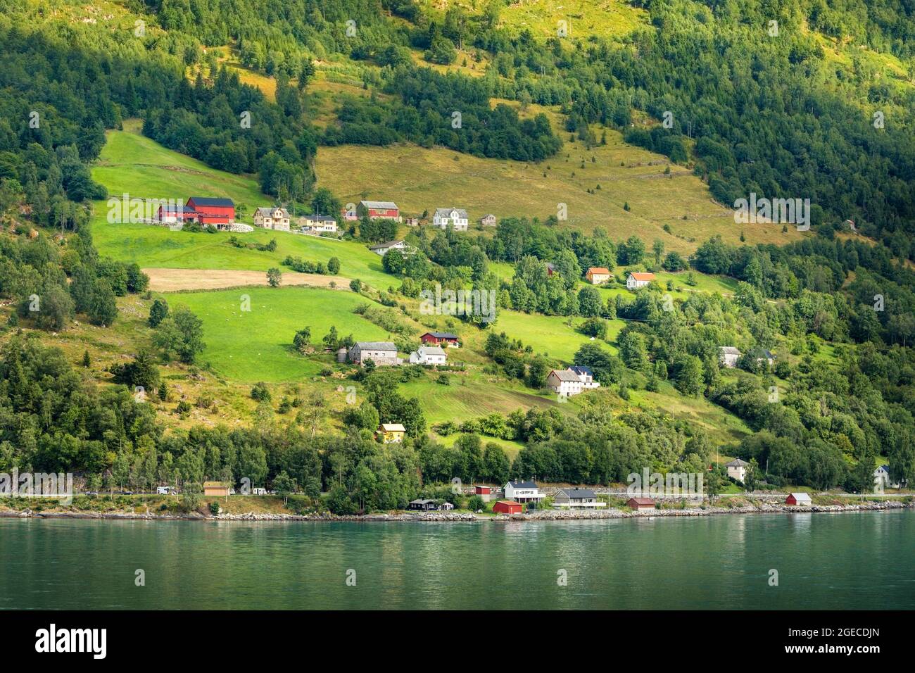 Norwegian village landscape with fjord, mountains and colorful houses ...