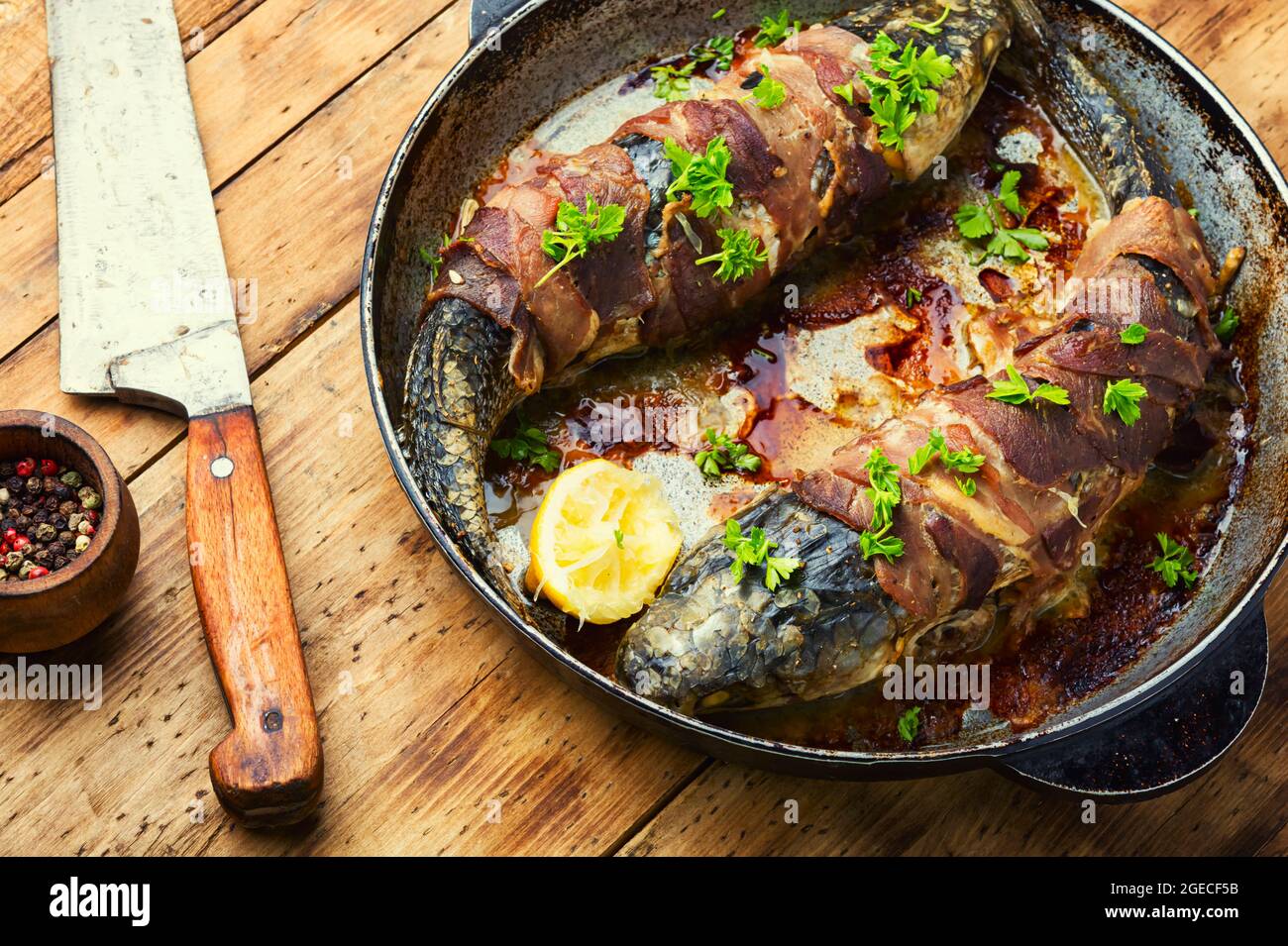 Baked fish wrapped in bacon, fried pelengas Stock Photo - Alamy