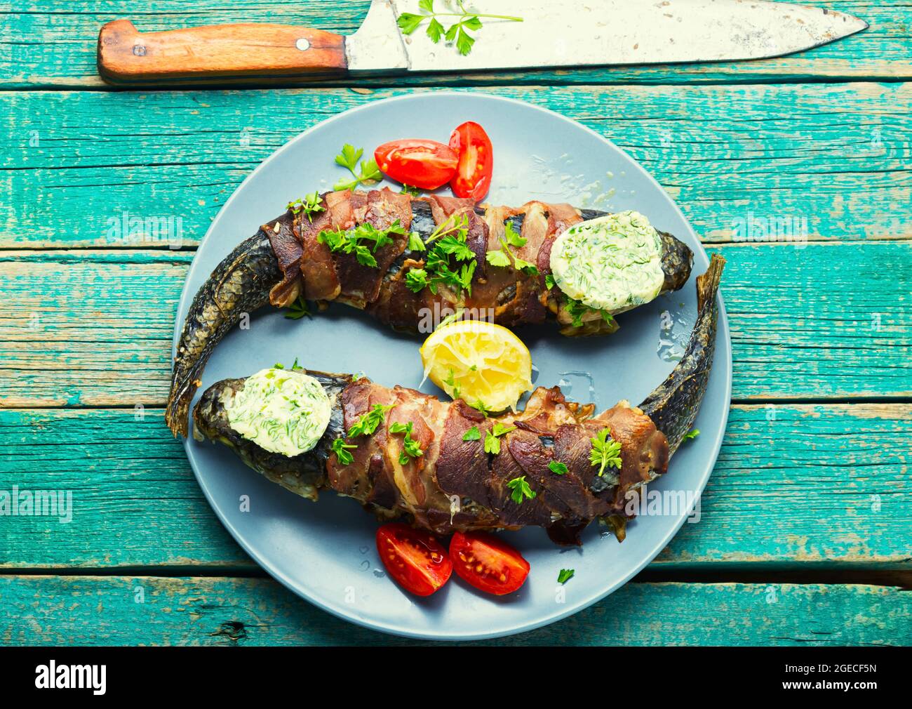 Baked fish wrapped in bacon, fried pelengas Stock Photo - Alamy