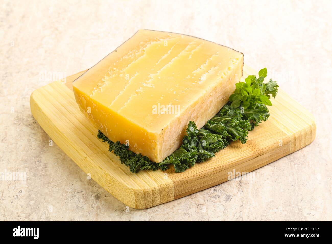 Hard Parmesan cheese piece over board Stock Photo - Alamy