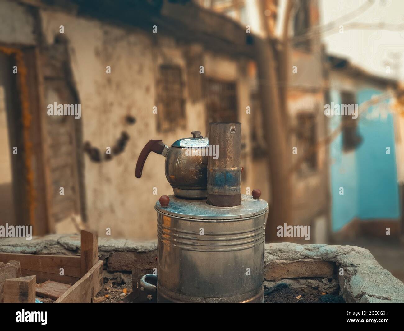Close-up photo of blackened metal teapot on old samovar stove in the ...