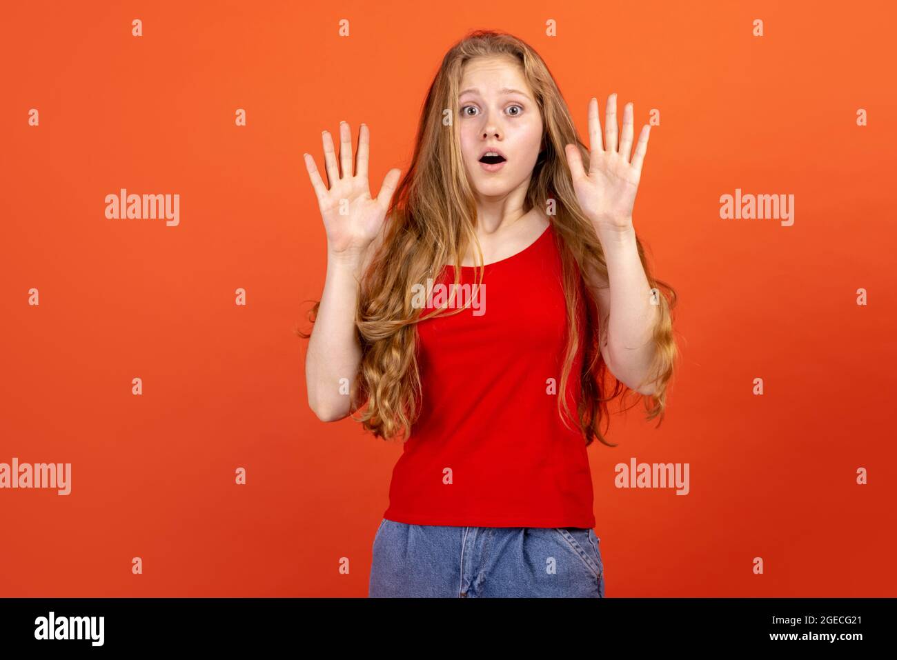 Horizontal portrait of young scared girl isolated on red studio ...
