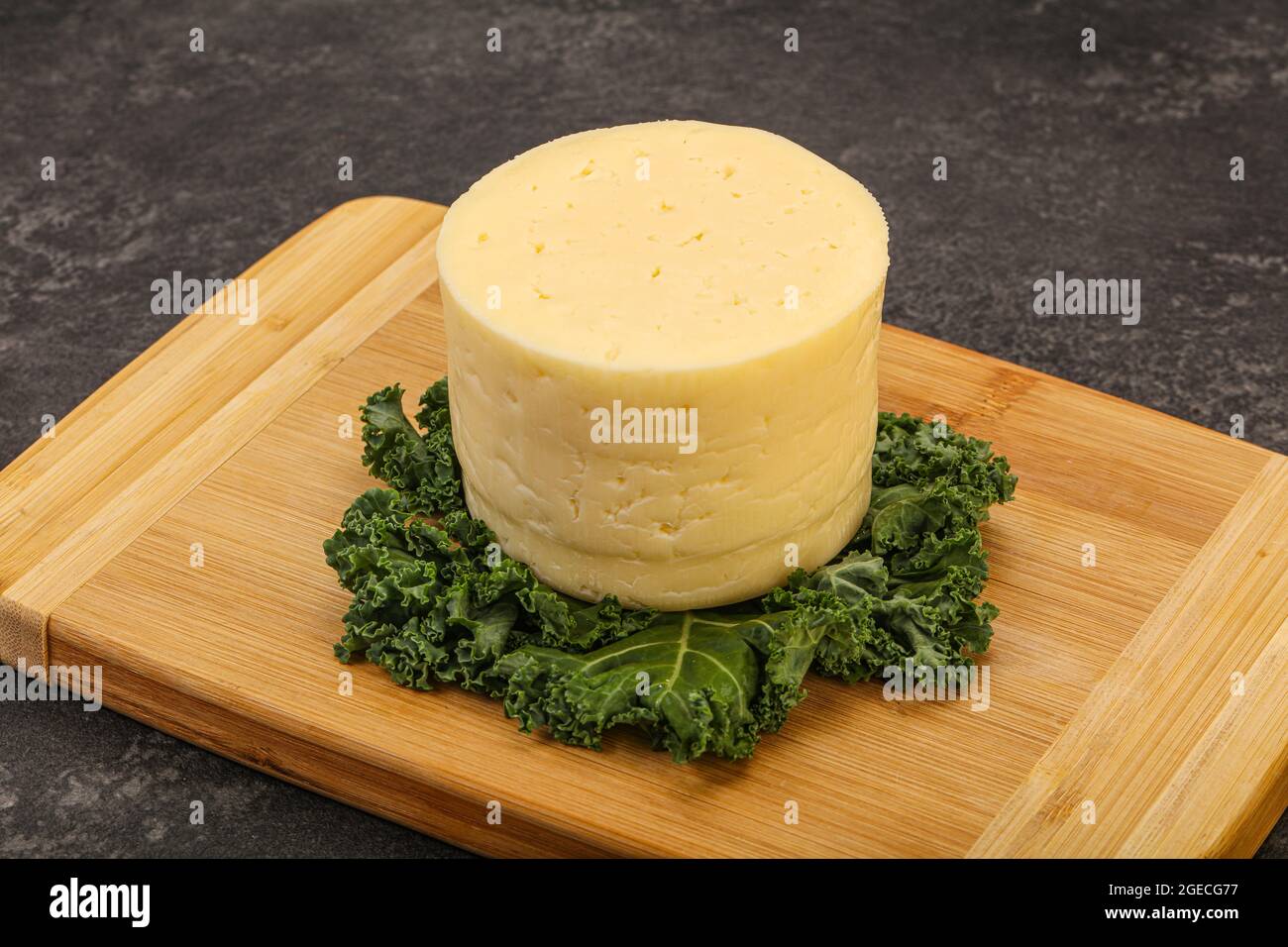 Yellow round dairy soft cheese piece Stock Photo - Alamy