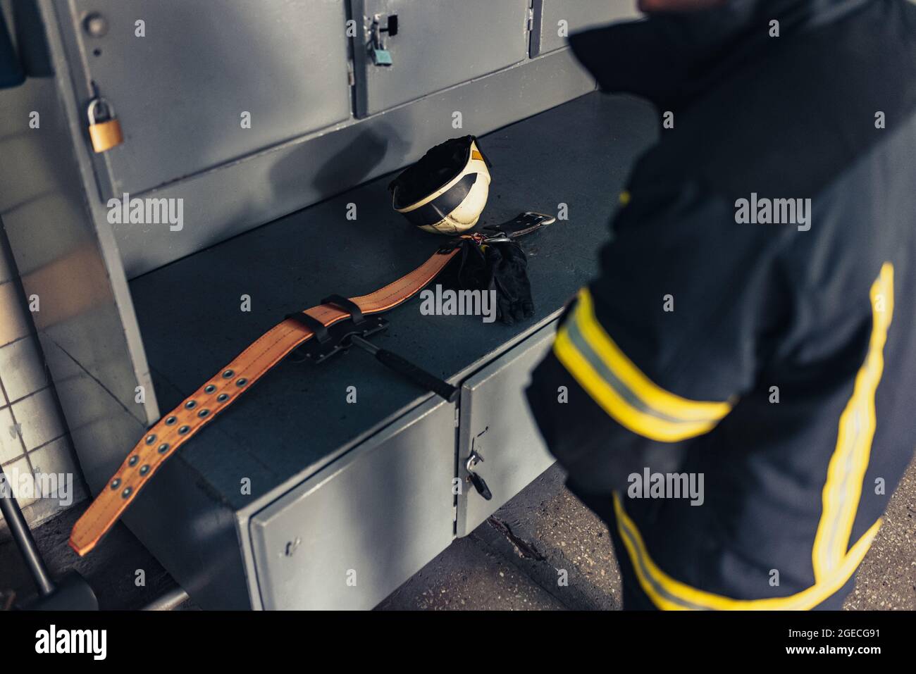 One male firefighter dressed in uniform with protective helmet at fire ...