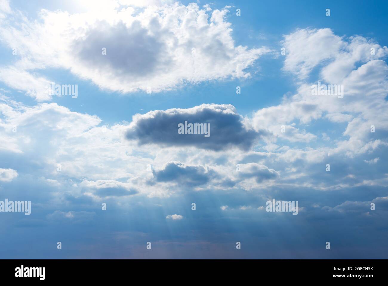 Dramatic blue sky with clouds and sun rays.Summer Sun rays at evening ...