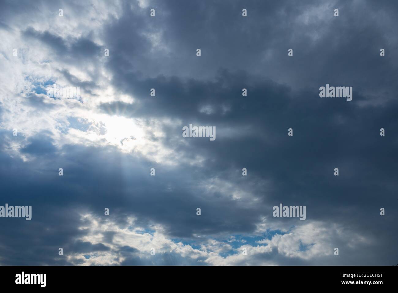 Dramatic blue sky with clouds and sun rays.Summer Sun rays at evening ...