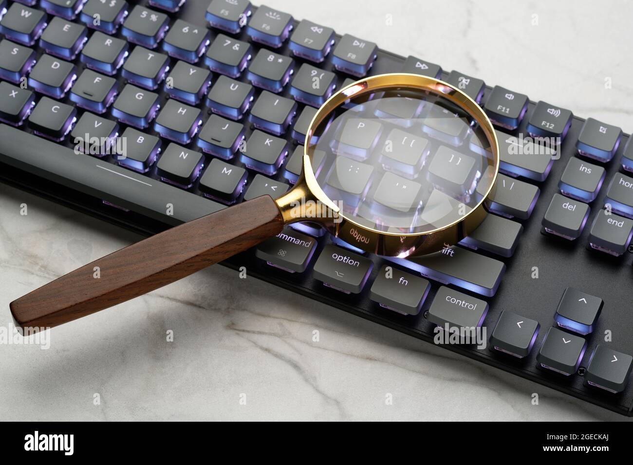 Magnifying glass on a computer keyboard. Illustrating a search of the ...