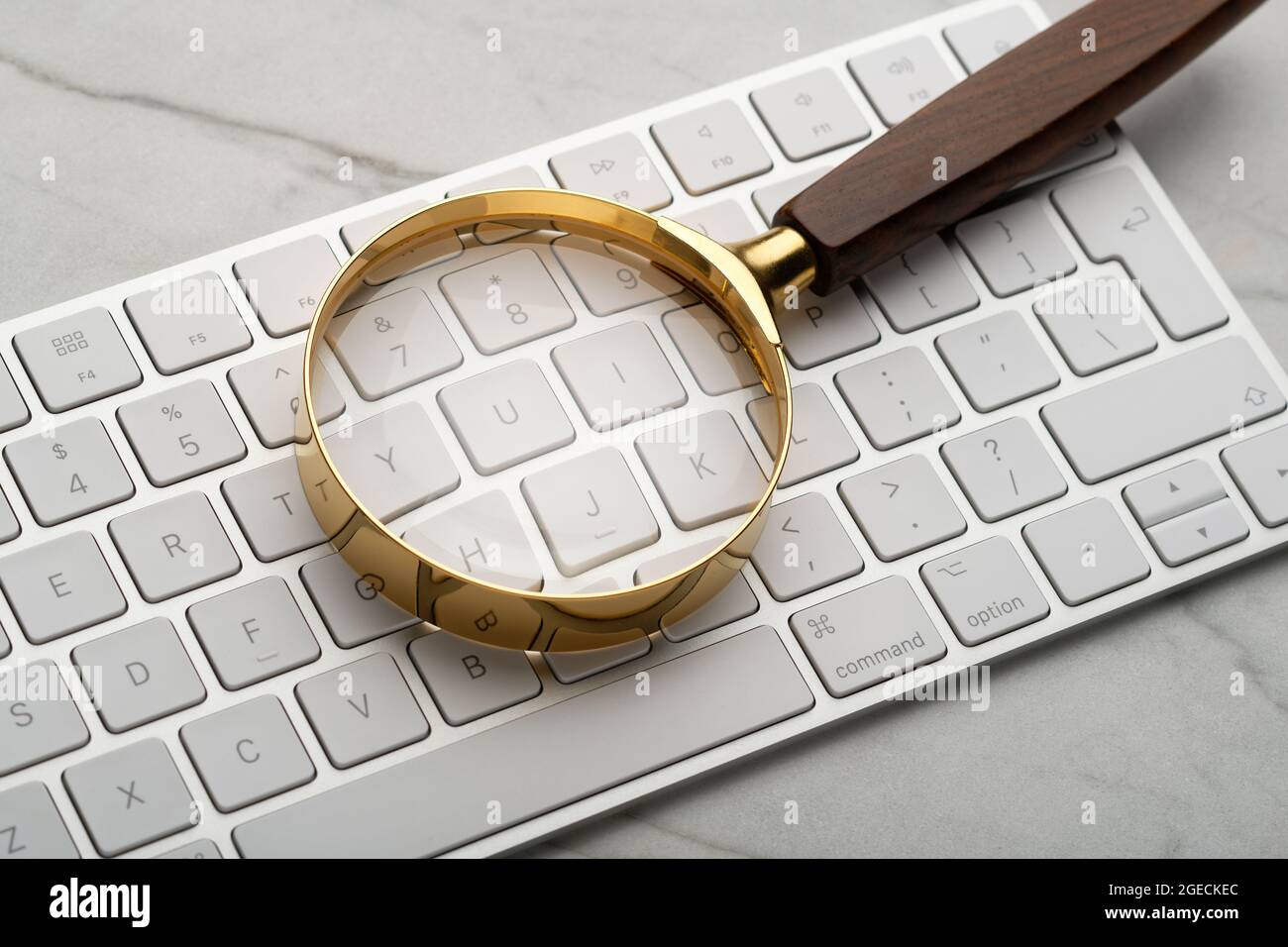 Magnifying glass on a computer keyboard. Illustrating a search of the ...