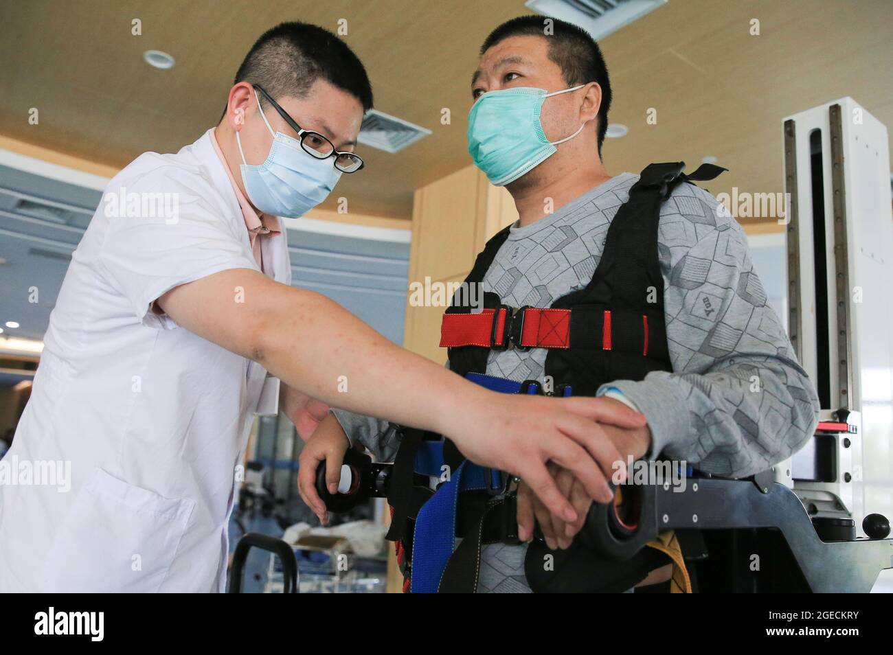 LIANYUNGANG, CHINA - AUGUST 19, 2021 - A physician instructs a patient ...