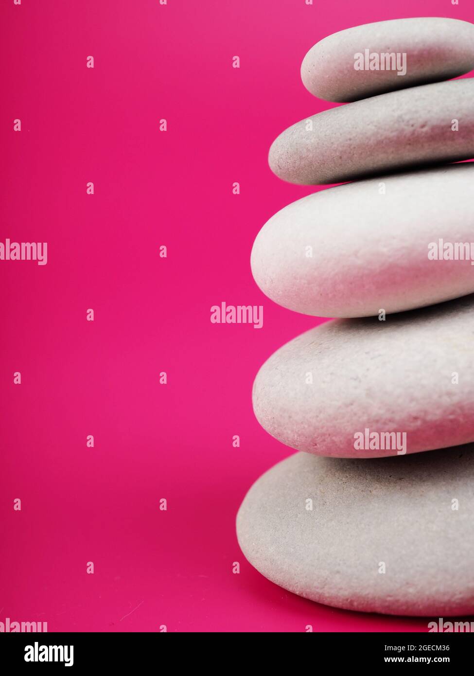 A stack of white zen stones on a pink background, minimalism Stock ...