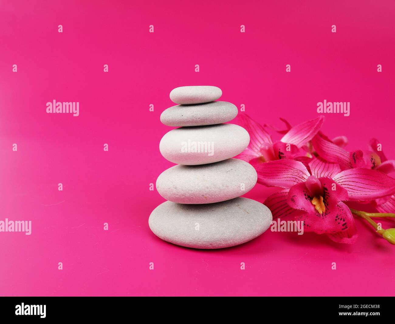 A stack of white zen stones on a pink background, minimalism Stock ...